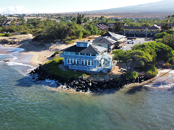 That blue house perched on the rocks looks like something from a Jimmy Buffett song.