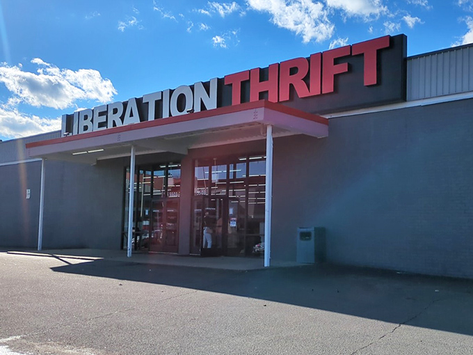 Liberation Thrift's bold red signage promises freedom from retail prices. A warehouse of wonders awaits inside!
