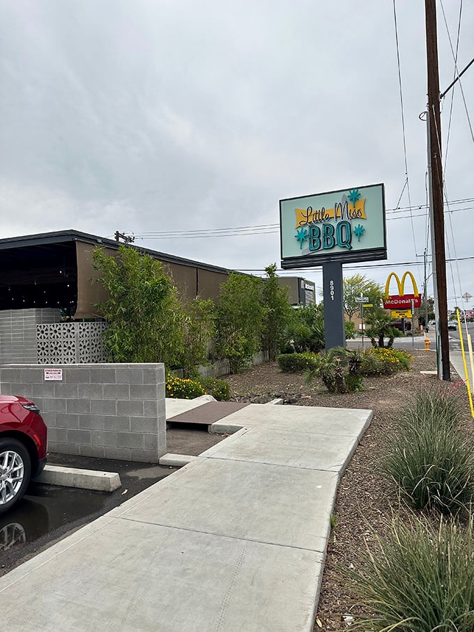 Rain or shine, that "Little Miss BBQ" sign beckons barbecue lovers like a smoky lighthouse guiding hungry ships to shore.