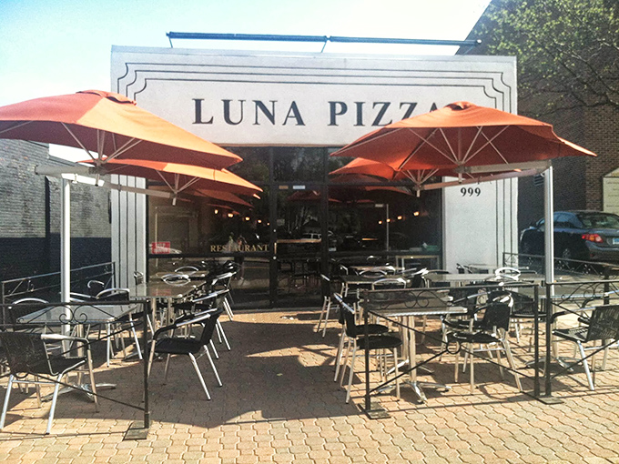 Luna Pizza's outdoor seating area is solar-powered by satisfaction. Those orange umbrellas have sheltered generations of happy pizza enthusiasts.