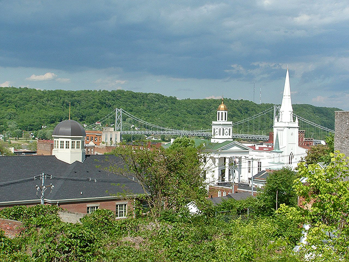 Maysville's skyline showcases its historic charm with church steeples and the iconic Simon Kenton Memorial Bridge stretching across the Ohio River.
