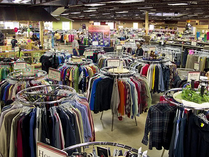 Circular racks create a forest of fashion possibilities. Navigate the well-organized wilderness of secondhand treasures.