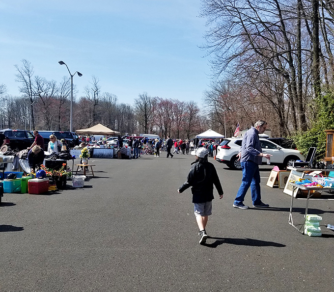 Deal-seekers paradise! Philadelphia Flea Market's outdoor aisles create a temporary city of treasures under brilliant blue skies.