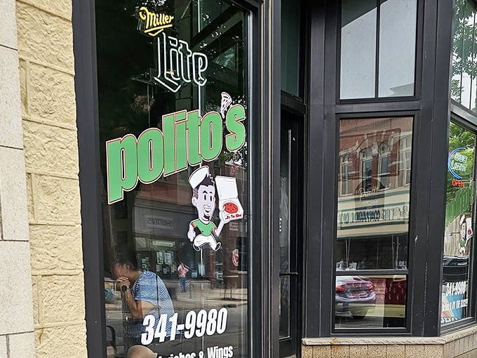 Polito's window cartoon mascot promises pizza with attitude. Those giant slices live up to the hype!