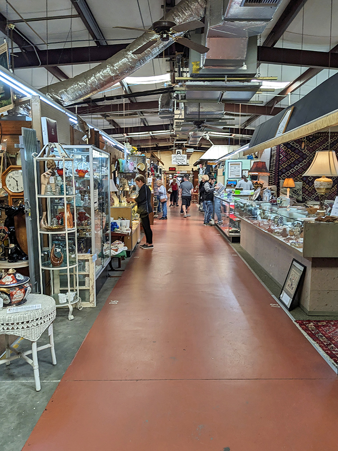 Antique heaven! Glass cases gleam with collectibles while shoppers hunt for that perfect piece to complete their home collection.