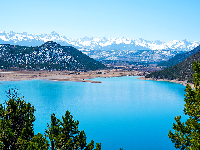 Mother Nature showing off again with this impossibly blue water. The mountains seem to lean in for a better look.