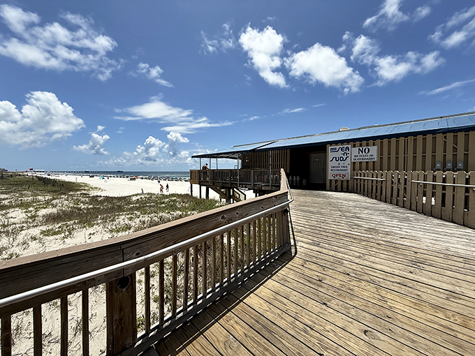 Sea N Suds wooden deck hovers between sand and sky in Gulf Shores. Seafood tastes better when your dining room is the beach!