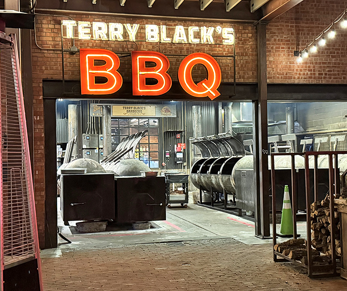 Terry Black's neon sign glows like a beacon for barbecue pilgrims. Those smokers aren't just equipment&mdash;they're time machines crafting flavor.