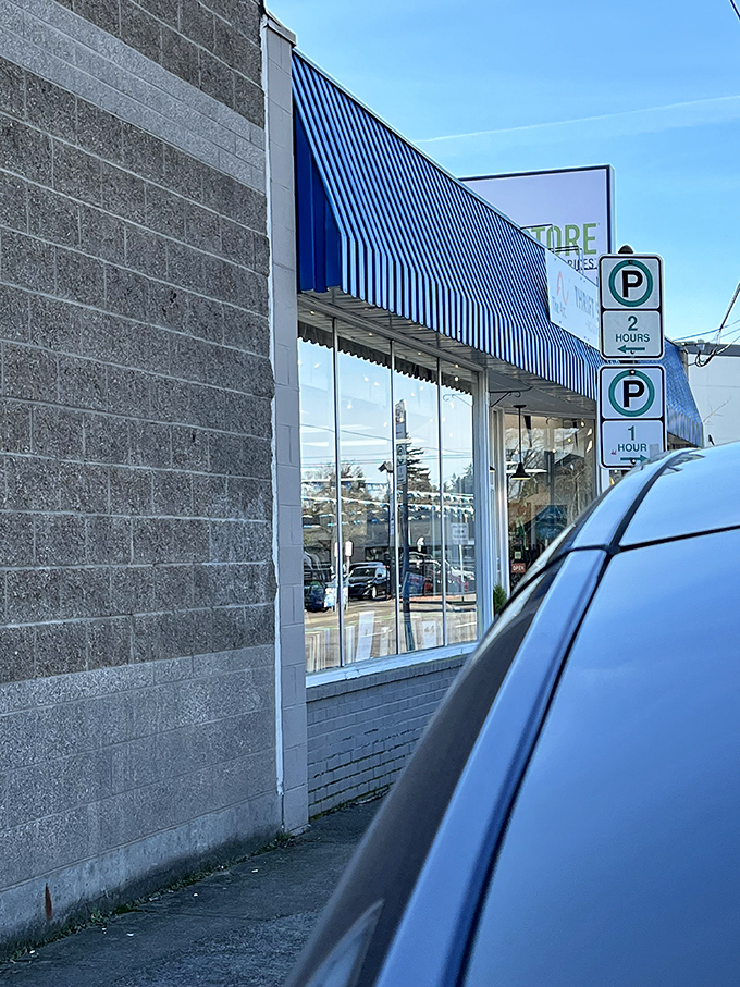 Blue awning, big bargains! The Arc Thrift Store's modest exterior hides a world of secondhand wonders inside.