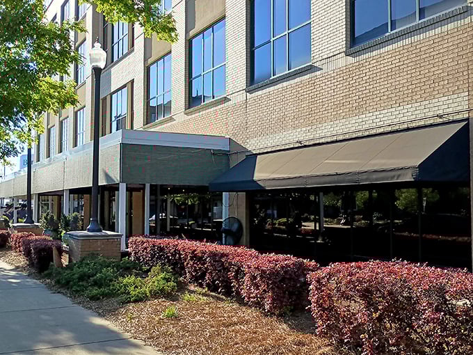 The Manship's modern brick exterior hints at the wood-fired wonders within. Urban sophistication meets primal cooking methods!