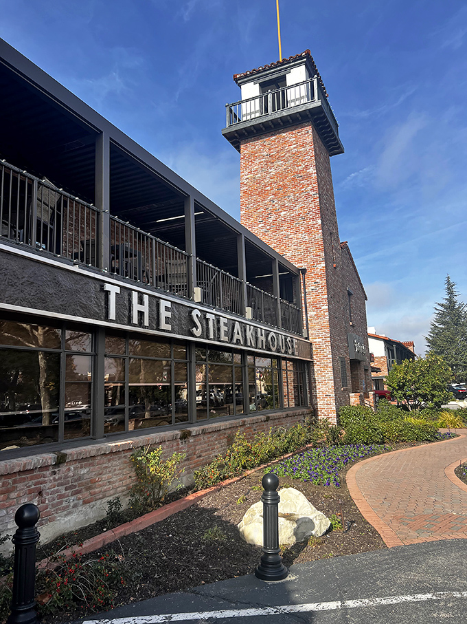 The Steakhouse's distinctive brick tower stands like a monument to meat mastery in Paso Robles wine country.