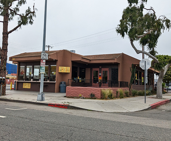 Tito's unassuming brown building - where taco magic happens without any architectural distractions.