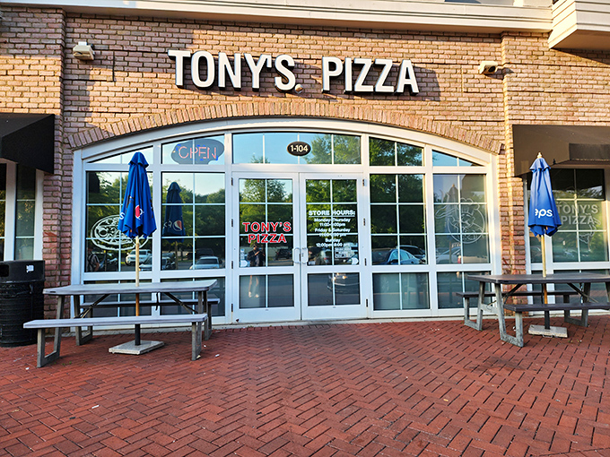 The welcoming brick facade and pristine windows hint at the neighborhood treasure waiting inside.