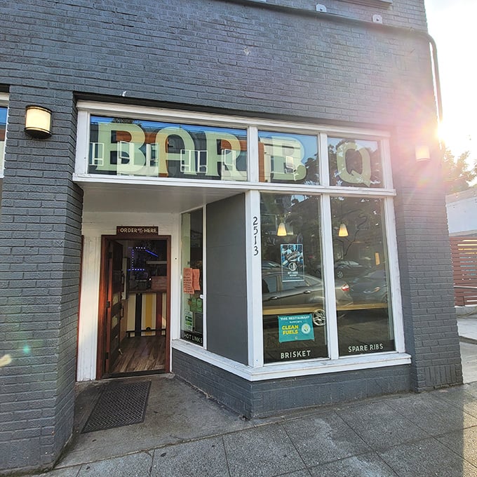 Wood Shop's sleek exterior might fool you, but that "BBQ" in the window tells the smoky truth about what awaits inside.