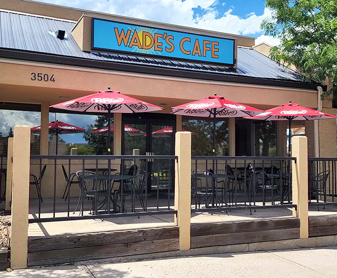 Wade's Cafe welcomes diners with its bright blue sign and inviting patio. Those red umbrellas practically whisper, "Come sit a spell and eat something delicious."