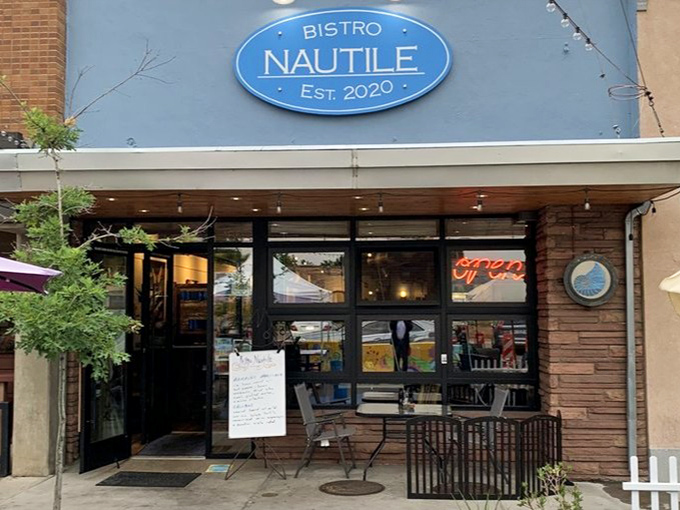 The cozy patio setup at Bistro Nautile feels like that perfect neighborhood spot you'd stumble upon during coastal vacations.