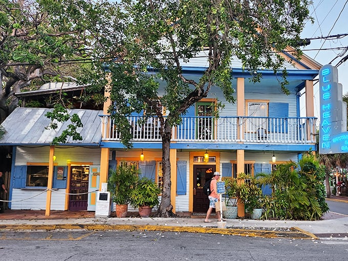Blue Heaven's charming two-story building welcomes visitors with tropical foliage and Key West's signature laid-back vibe.