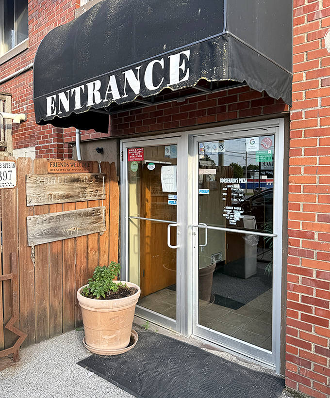 That simple "ENTRANCE" sign might as well say "PORTAL TO PIZZA PARADISE"—some of life's greatest pleasures come without fanfare.