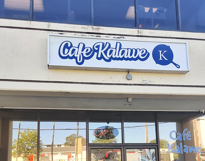 Blue signage against white walls &ndash; simple, straightforward, and promising exactly what you need: great food without the fuss.