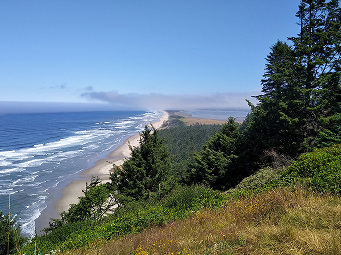 Morning mist rolls across Cape Lookout's shore &ndash; nature's way of saying "good morning" with dramatic flair.