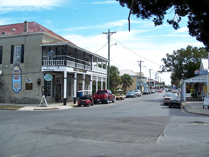 Historic buildings line Cedar Key's waterfront district, where seafood is served fresh and conversations flow as easily as the tide.