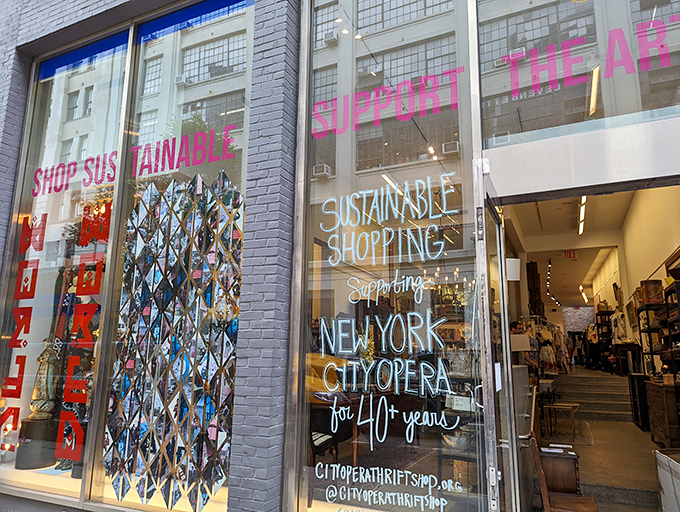 Where fashion meets philanthropy in neon pink! City Opera's geometric window display promises sustainable style with a side of cultural preservation.