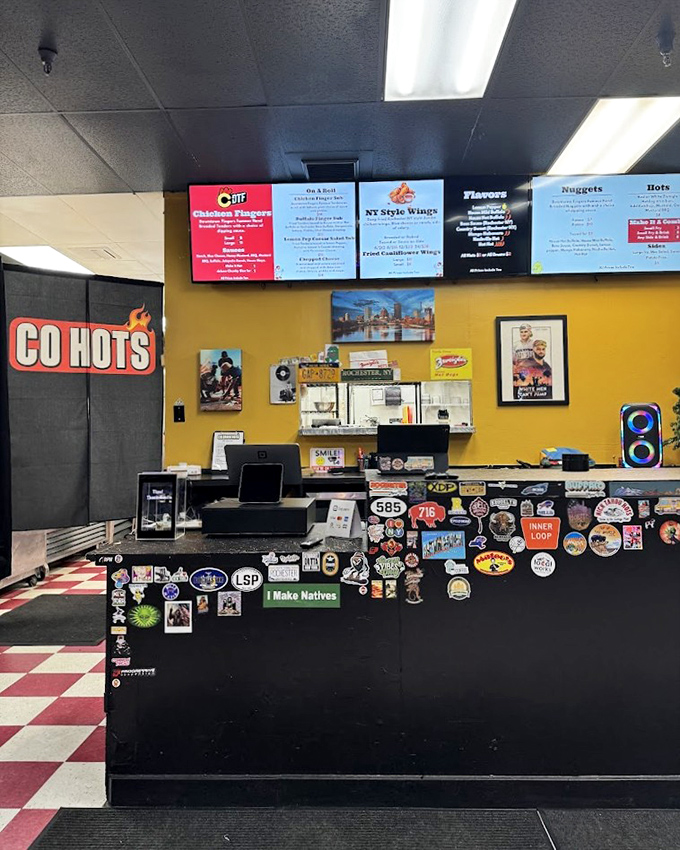 The sticker-covered counter tells stories of chicken adventures past. Each one represents someone who couldn't resist coming back for more.