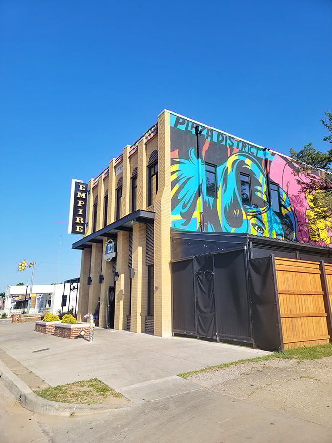 Art on the walls, art on your plate! Empire Slice House's vibrant exterior hints at the equally colorful pizza creations waiting inside.