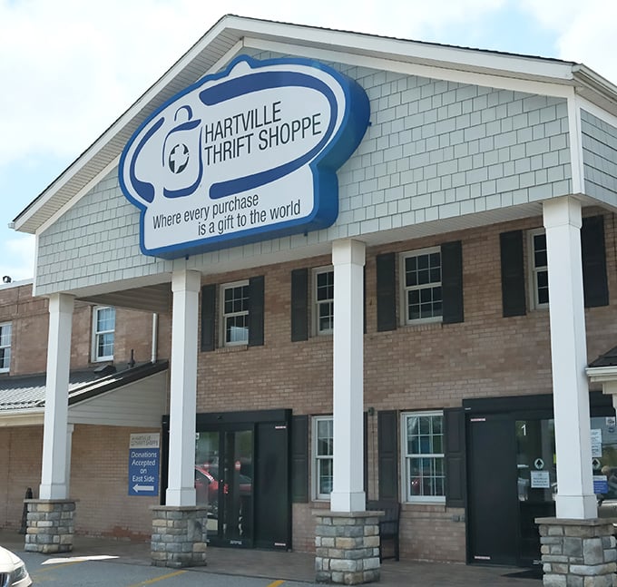 Stone columns and friendly signage create the perfect first impression for serious thrift store adventurers.