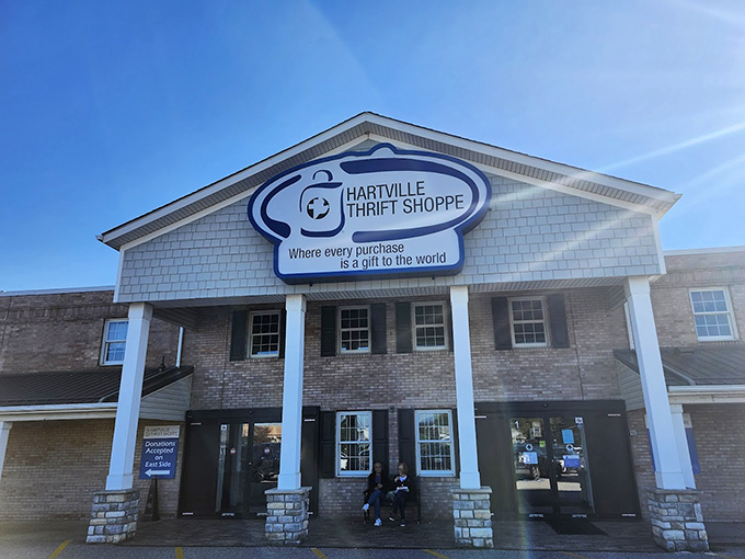 Sunshine, columns, and charitable shopping! Hartville's thrift headquarters welcomes visitors with architectural flair and benches for weary bargain hunters.