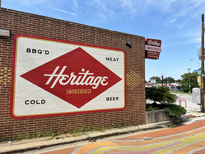 The unassuming exterior of Heritage hides Baltimore's smokiest secret. That classic red diamond logo promises authentic BBQ craftsmanship within these walls.