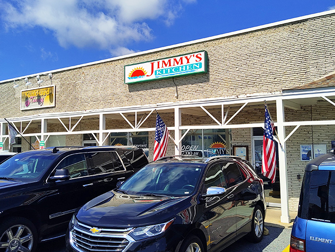 American flags flutter outside Jimmy's Kitchen, where patriotism meets pancakes in a brick-front beacon of breakfast excellence.