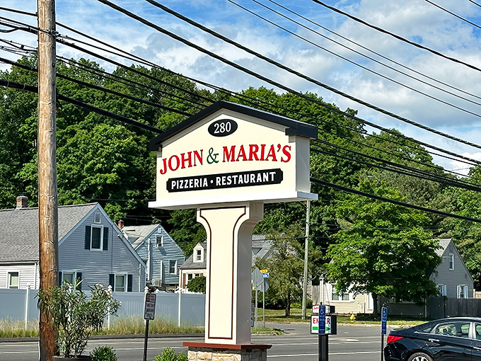 The roadside sign for John & Maria's stands tall like a pizza lighthouse. Guiding hungry travelers to a safe harbor of cheese and toppings.