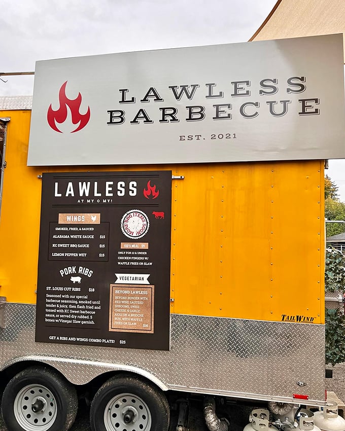 Mobile meat mastery! This yellow-trimmed BBQ trailer brings the smoke wherever it roams, with wings that'll make you sing.