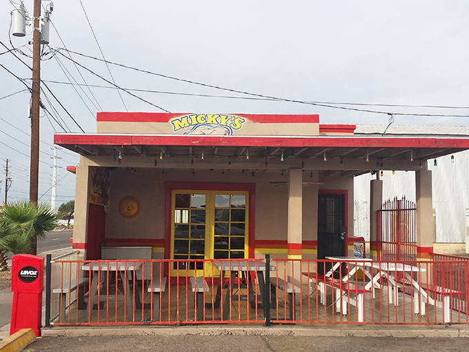 The bright yellow "Micky's Hot Dog" sign stands out against the blue sky&mdash;a beacon for bacon-wrapped dog enthusiasts.
