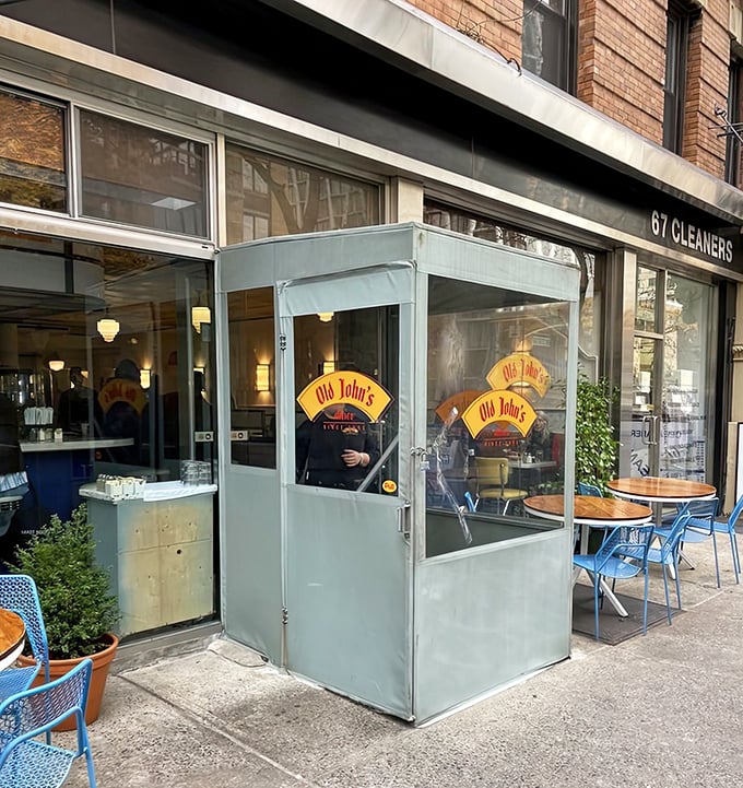 That cozy entrance booth at Old John's looks like it's giving the sidewalk a hug. Inside, your breakfast awaits!