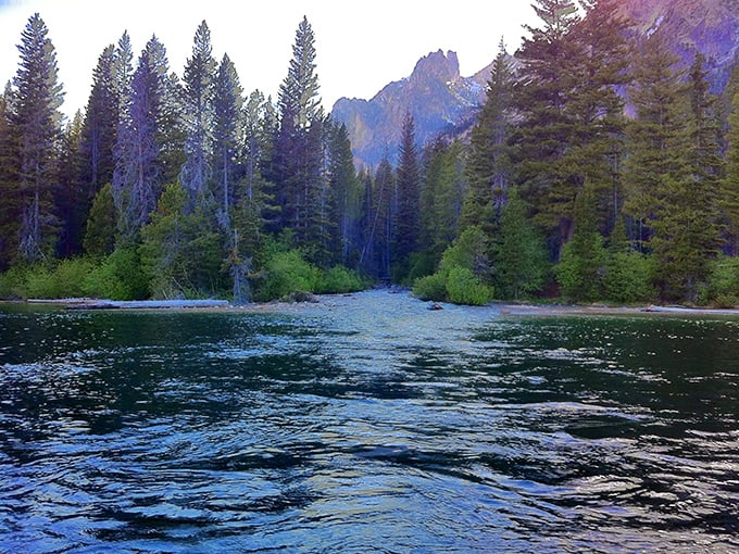 Mountain reflections dance across the surface at Orval Hansen Point Beach. Serenity comes standard with every visit.