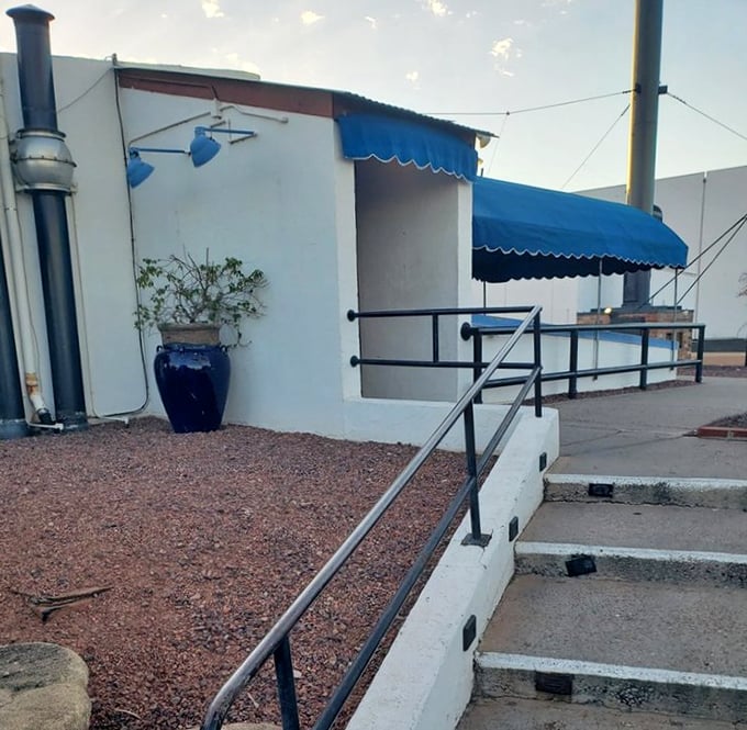 A blue awning and desert landscaping mark the spot where seafood lovers descend into Salt Cellar's subterranean dining rooms. The journey down is worth every step.