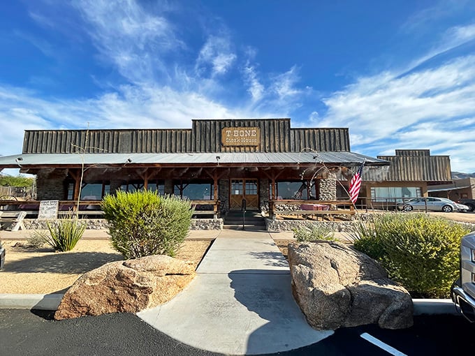Desert landscaping frames T-Bone's frontier-style entrance. This is where carnivores come to worship at the altar of mesquite-grilled perfection.