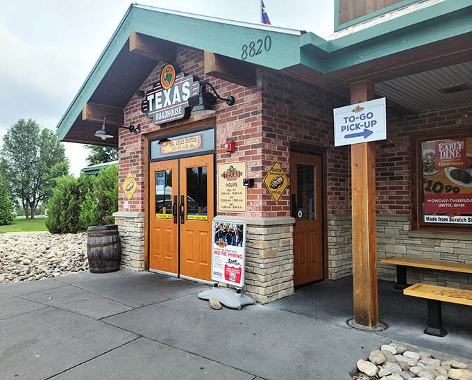Morning light showcases the welcoming entrance of Texas Roadhouse. Those wooden doors might as well be portals to brisket heaven.
