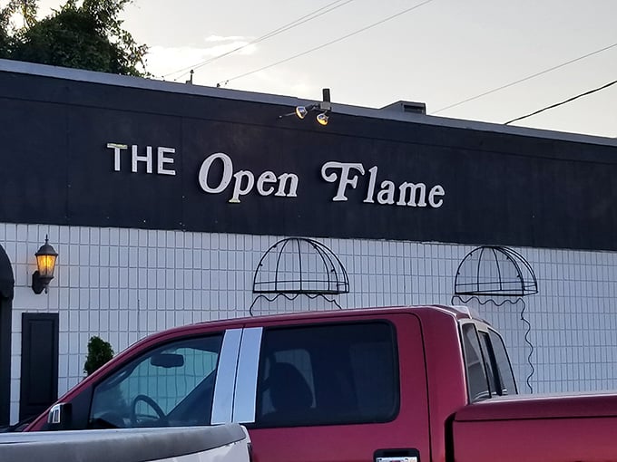 That charming white tile exterior with classic signage evokes memories of when steakhouses were neighborhood gathering spots, not corporate chains.