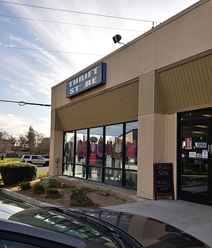 Sunlight casts a golden glow on Thrift City's storefront, where tomorrow's outfit waits patiently for its second chance.