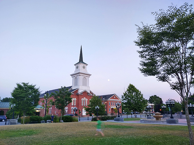 The beautiful town green in Westfield shines at sunset, with its charming church steeple and peaceful community park setting.
