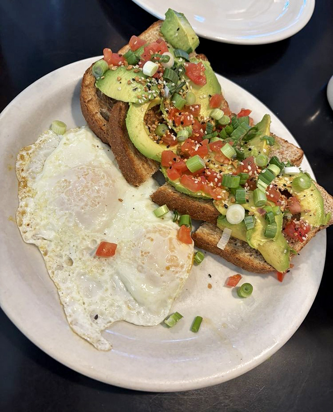 Avocado toast that doesn't require a second mortgage&mdash;topped with fresh tomatoes, green onions, and enough healthy fats to fuel a morning hike.