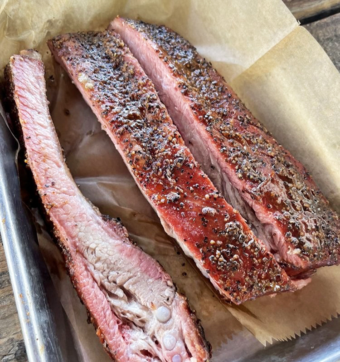 These ribs have the perfect bark-to-meat ratio that BBQ dreams are made of. The pink smoke ring is nature's way of saying "this was done right."