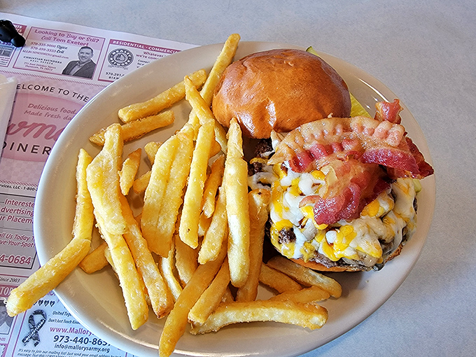 The burger arrives with fries standing at attention like golden soldiers, while bacon peeks out saying, "You made the right choice today, friend."