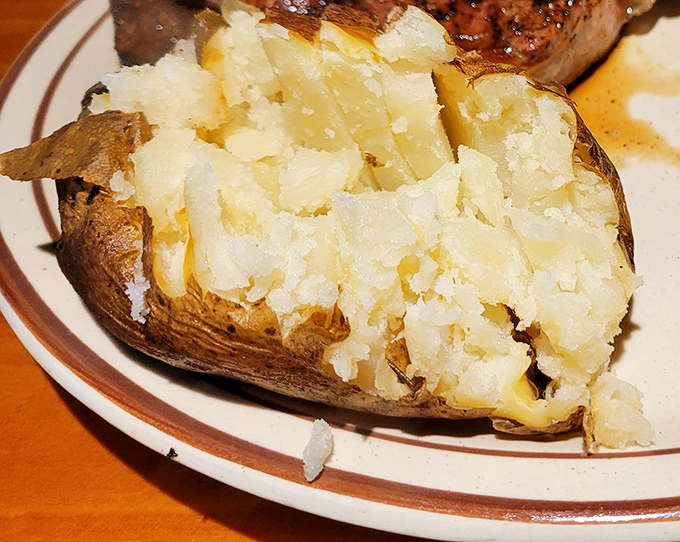 The humble baked potato, fluffy as a cloud and ready for its supporting role in the steak show. Oscar-worthy performance guaranteed.