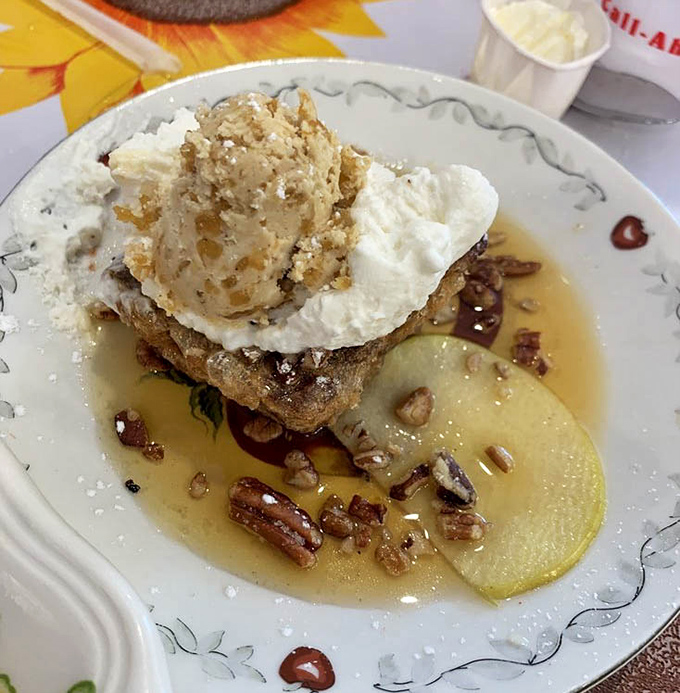 Banana bread French toast piled with candied apples and whipped cream makes regular breakfast look like it's not even trying.