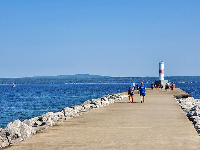 Petoskey's breakwater pier stretches into Lake Michigan like nature's red carpet, inviting visitors to walk straight into that perfect summer postcard.