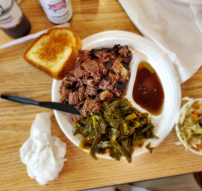 Brisket that doesn't need fancy plating to impress. Those tender chunks of beef alongside collard greens tell a story of patience and smoke that words can't capture.